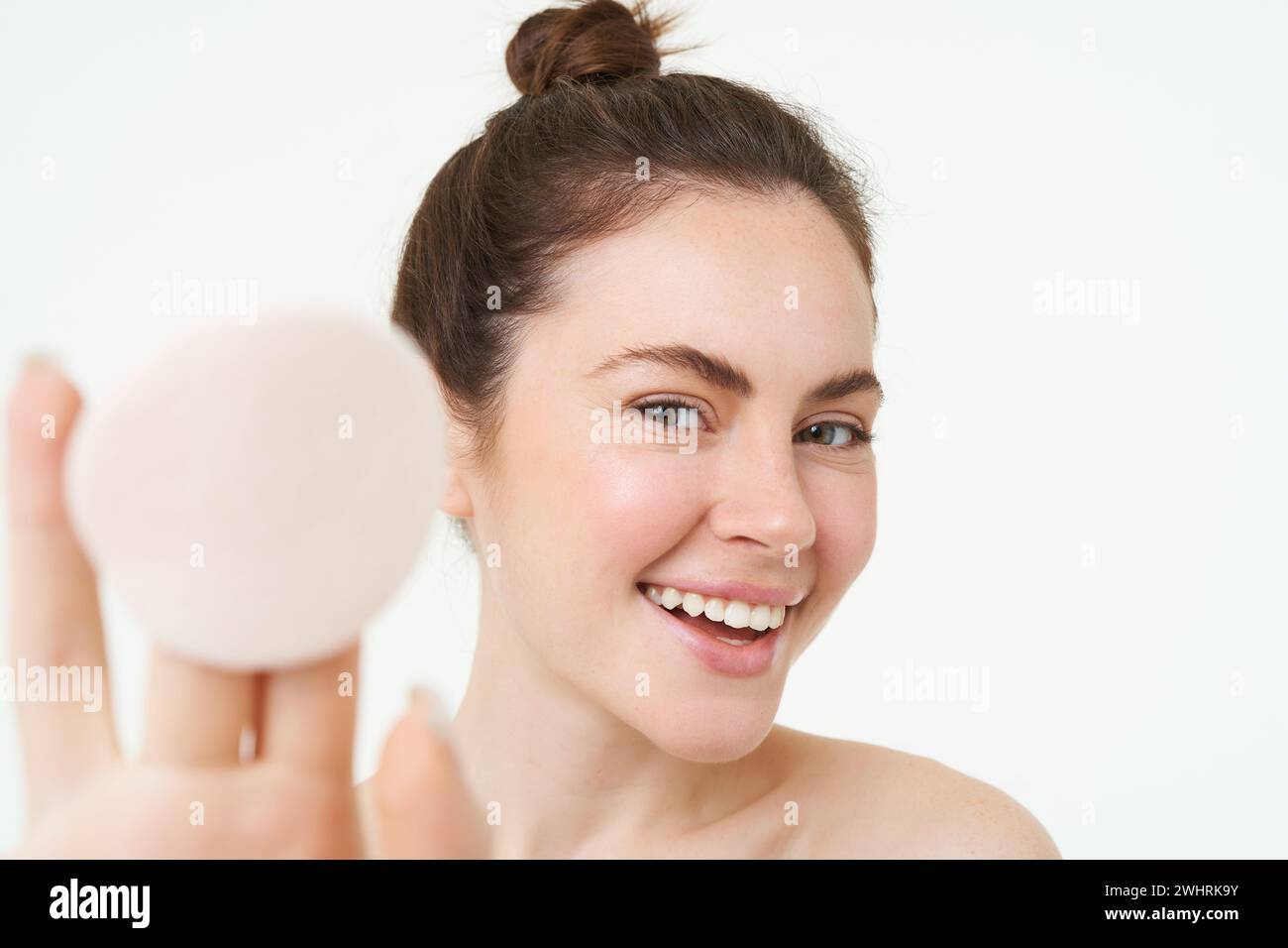 Beauty portrait of young female model, showing cosmetic makeup pad ...