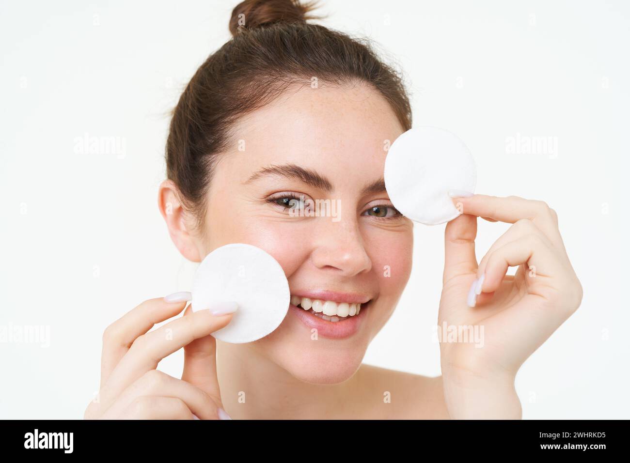 Beauty woman with clear glowing face, showing cotton cosmetic pads for ...
