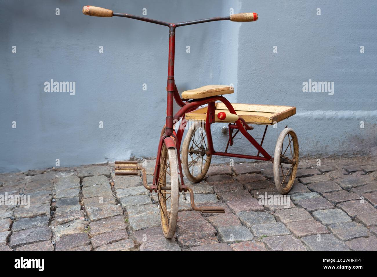 Three wheel vintage bike on stone paved sidewalk. 1940s retro-styled ...
