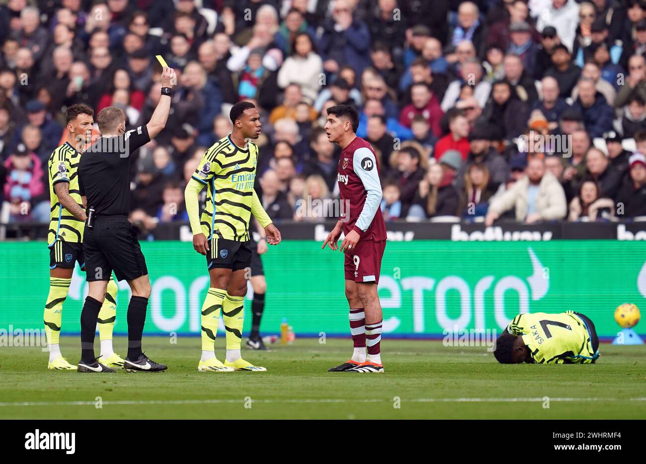 West Ham United's Edson Alvarez (centre) is shown a yellow card by ...