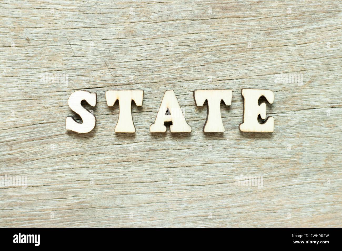 Alphabet letter in word state on wood background Stock Photo - Alamy