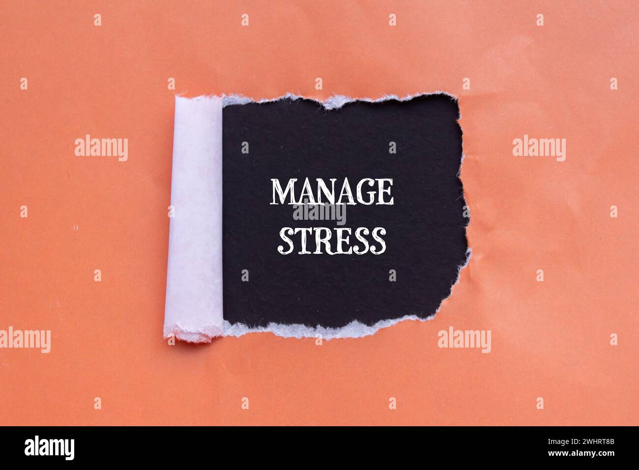 Manage stress lettering on orange torn paper with black background ...