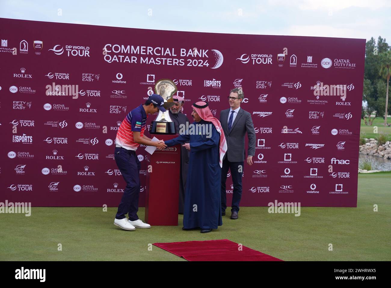 Japan’s Rikuya Hoshino receives a gift voucher from Qatar Golf Association President Hassan Al ...