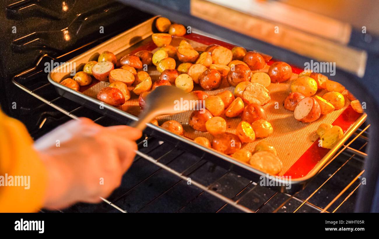 Man in kitchen preparing dinner hi-res stock photography and images - Alamy