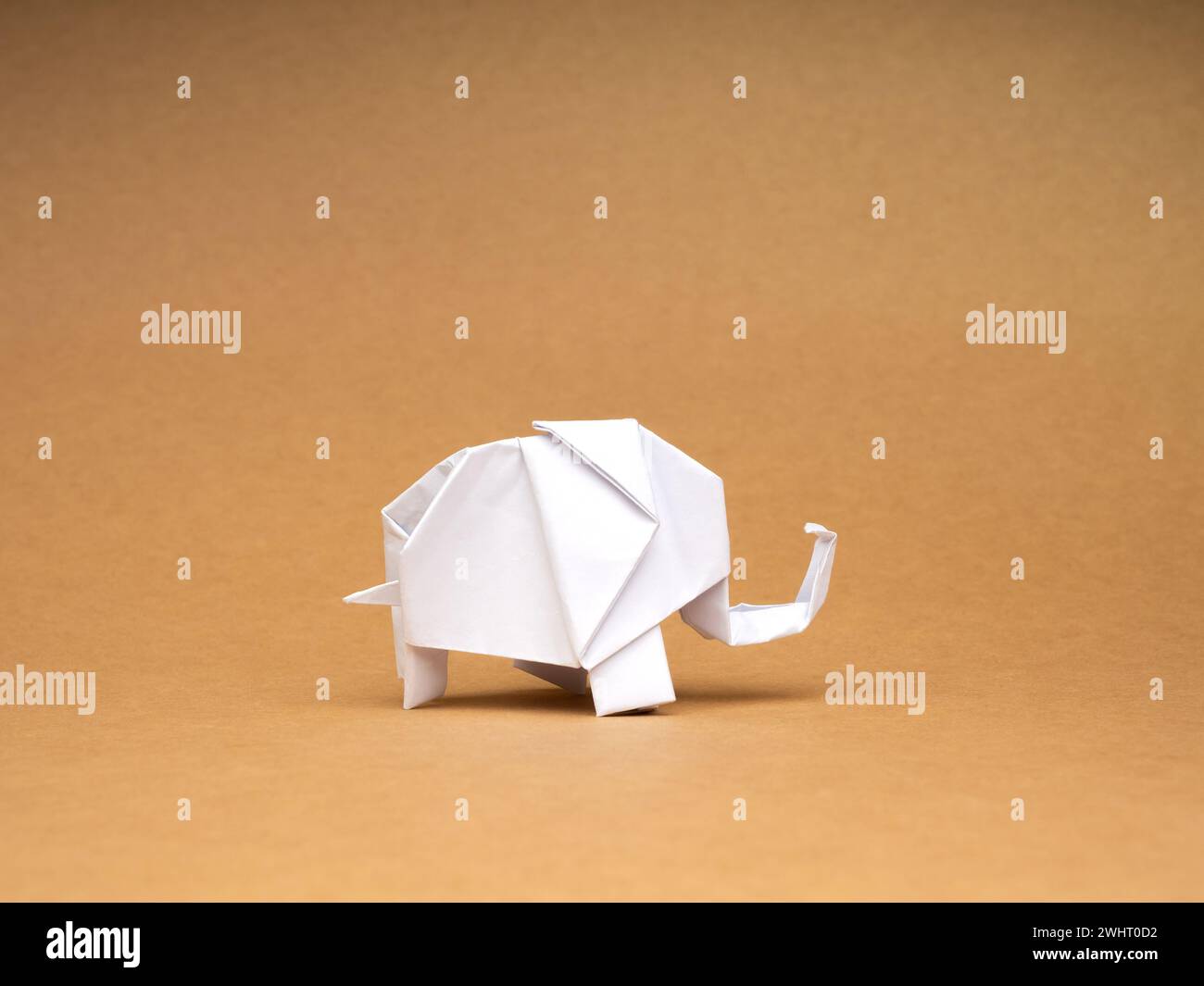 A white elephant paper standing isolated on eco brown kraft paper ...