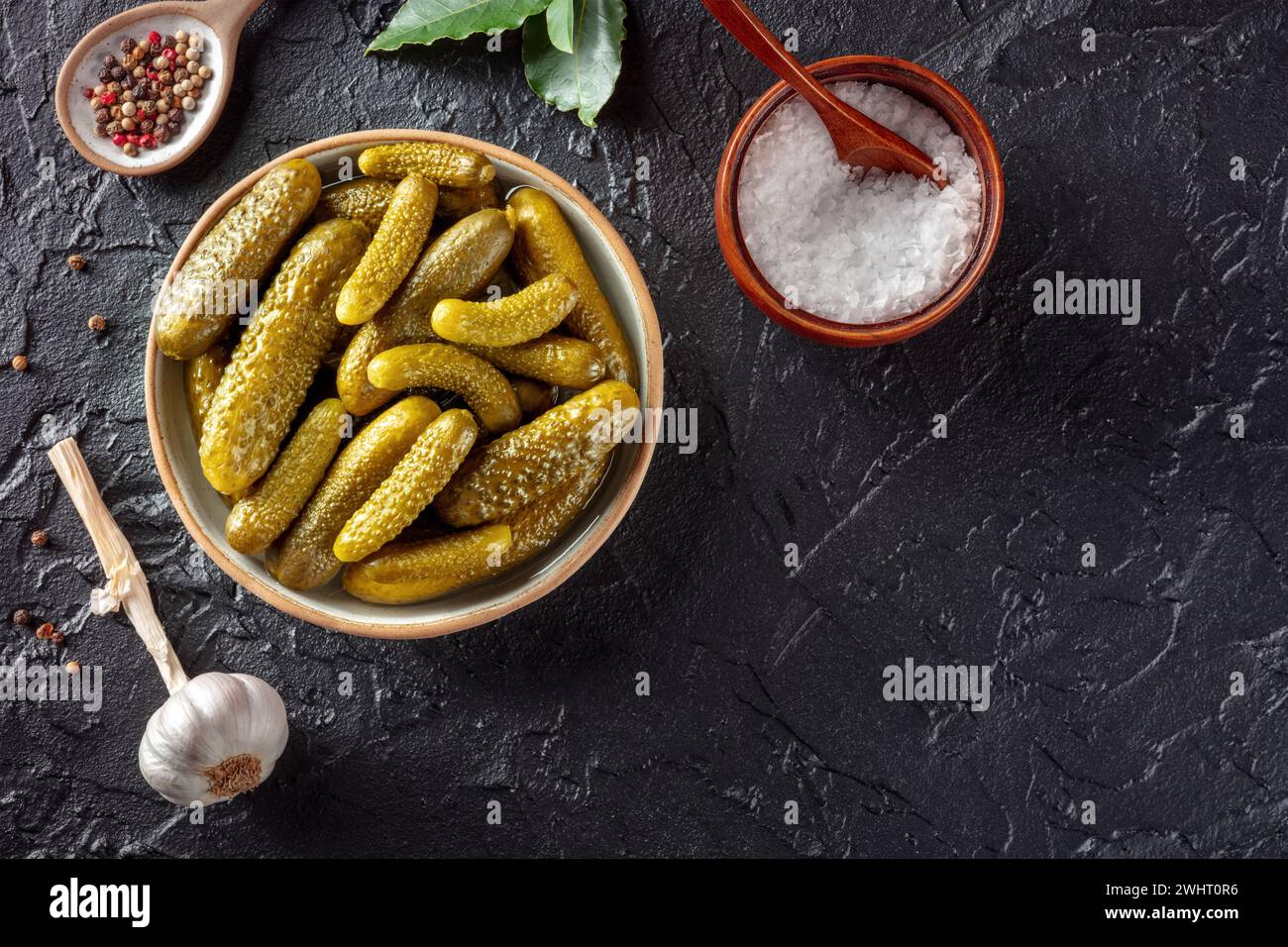 Pickled cucumbers with salt, pepper, garlic, and bay leaf Stock Photo ...