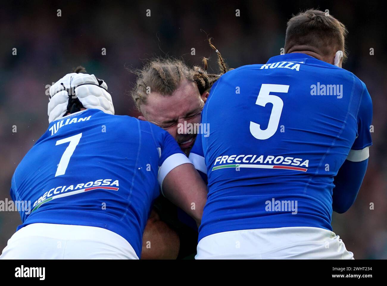 Ireland's Finlay Bealham (centre) is tackled by Italy's Manuel Zuliani ...