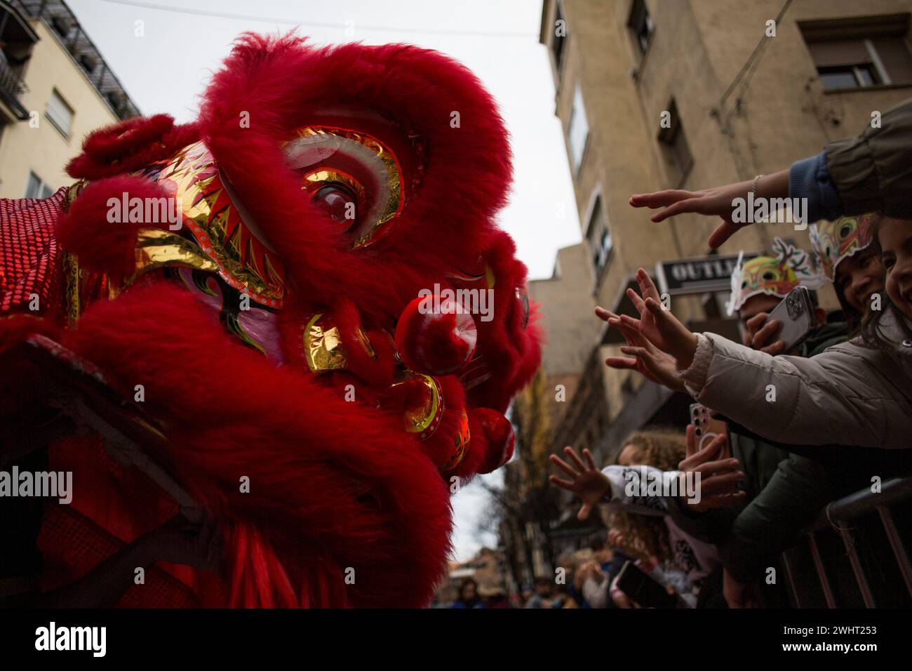 Madrid, Madrid, Spain. 11th Feb, 2024. Chinese lion dancers approach ...