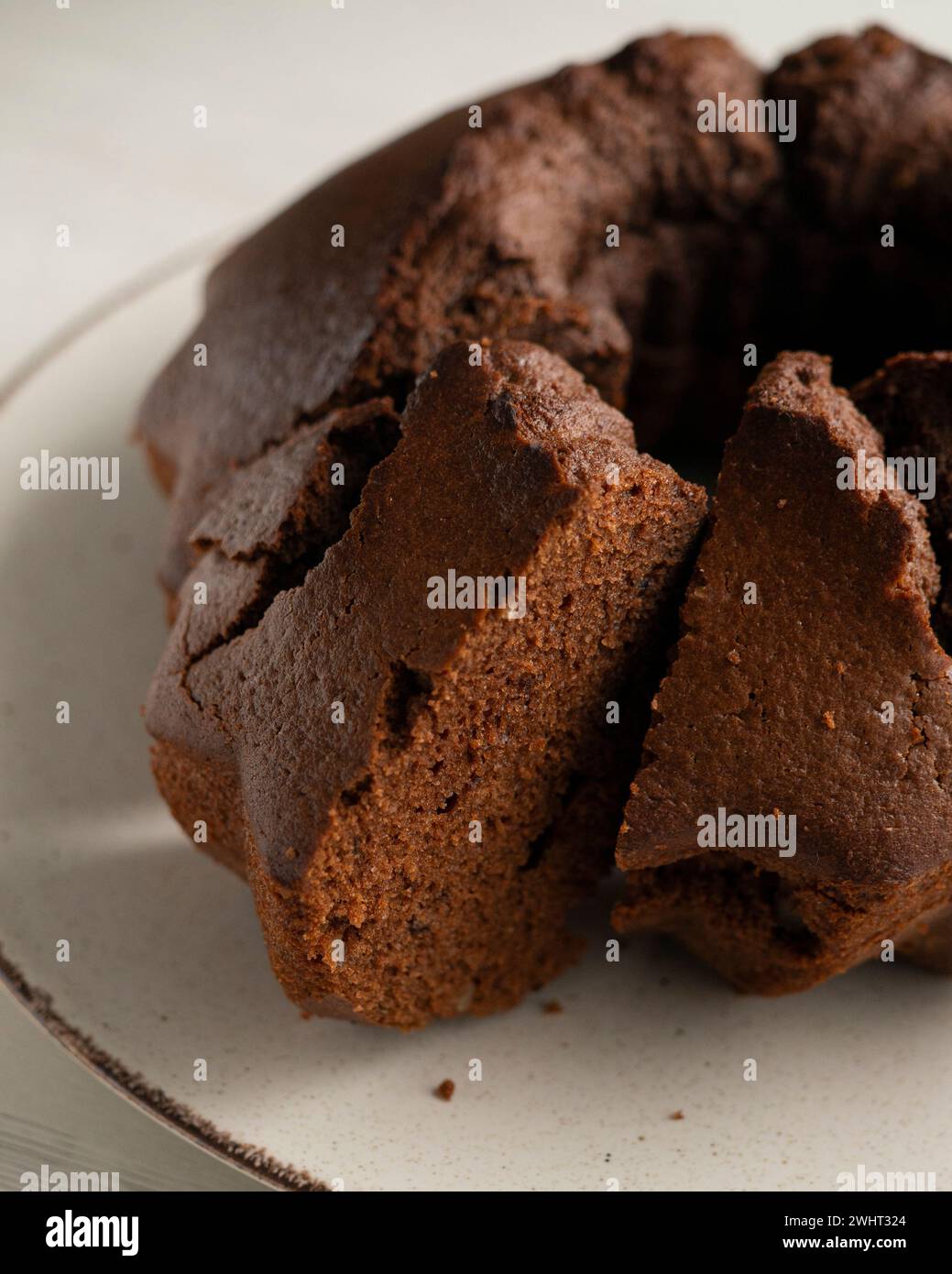 Delicious and fluffy round chocolate cake with cashews and raspberries ...