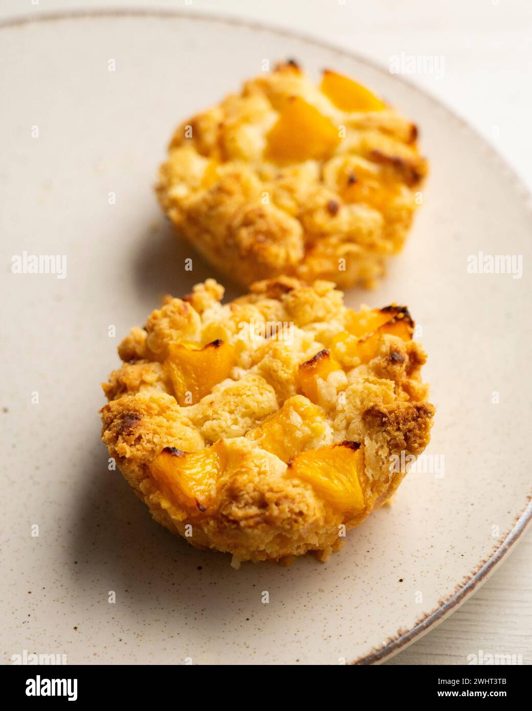 Peach crumble tartlet in a French pastry shop in Paris Stock Photo - Alamy