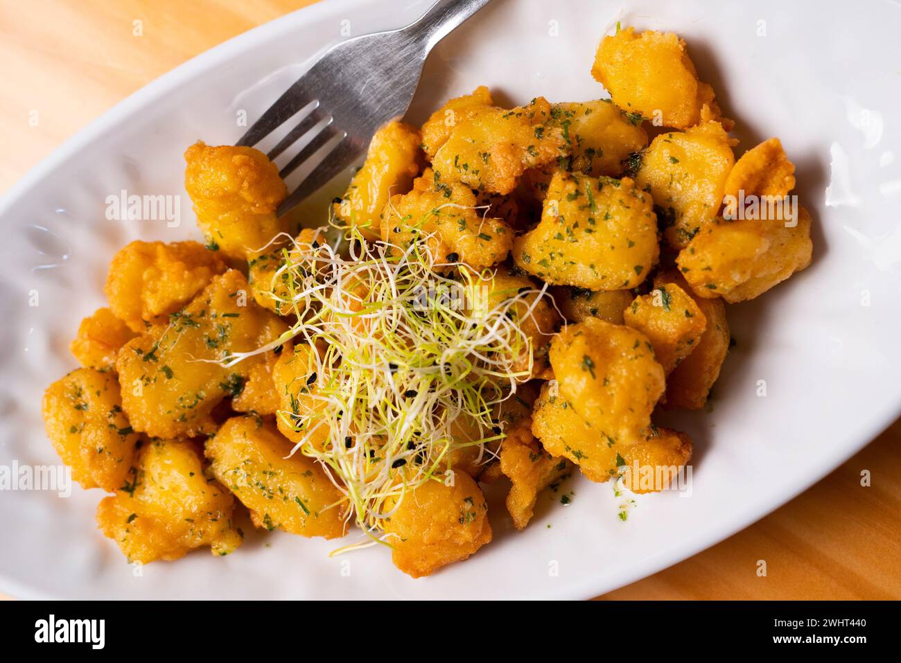 Fried cuttlefish with garlic and parsley. Traditional fried fish tapa ...