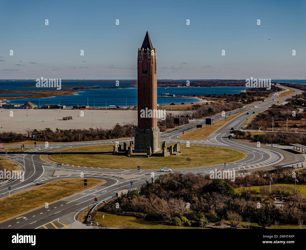 Intersection with two roads and clock tower near ocean Stock Photo - Alamy