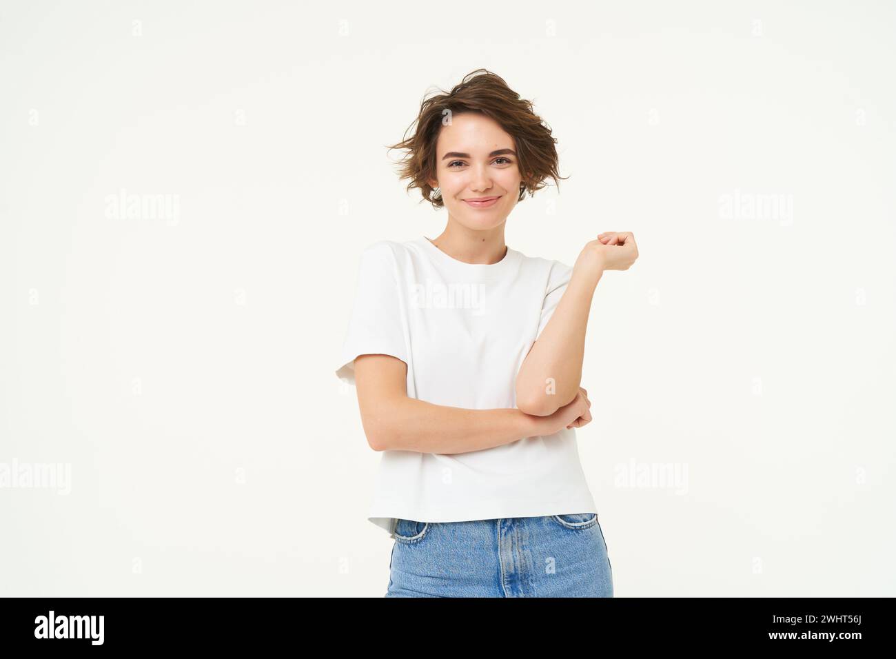 Portrait of woman standing in power pose, confident expression, cross ...