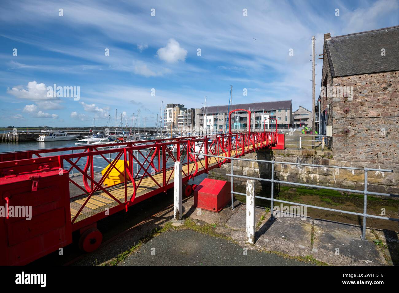 Red footbridge beside the Victoria Dock area of Caernarfon on the coast ...