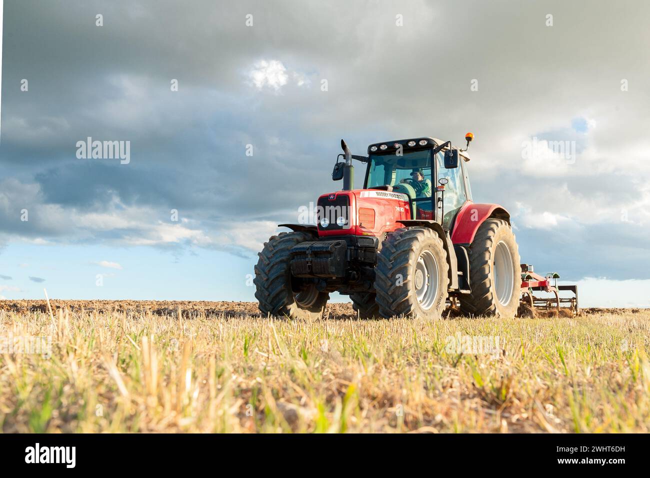 Agricultural machinery carrying out field work during the cereal ...