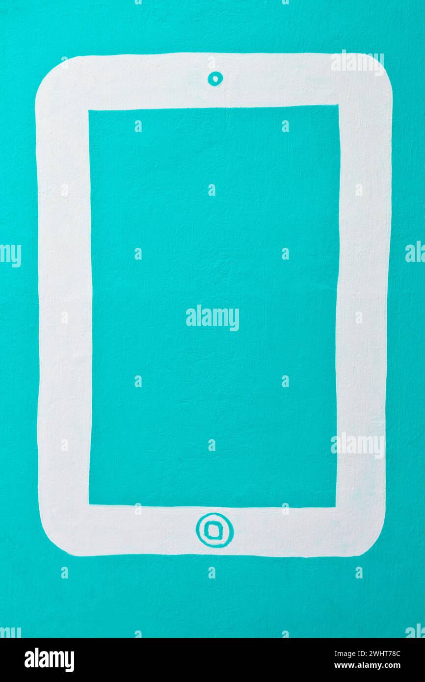 Tablet PC pictured at bright turquoise wall Stock Photo - Alamy