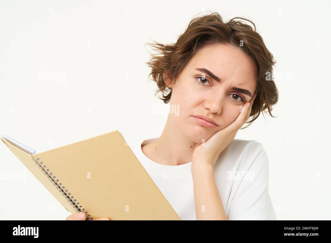 Image of troubled, upset young woman, student looks complicated, holds ...