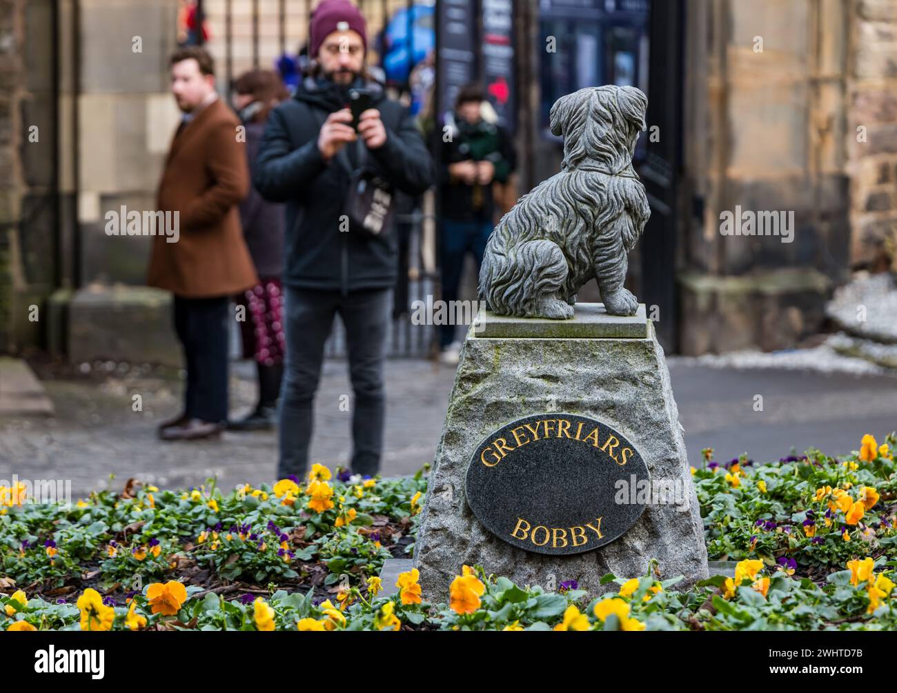 Tourist taking photo of Greyfriar's Bobby dog statue, Greyfriar's ...