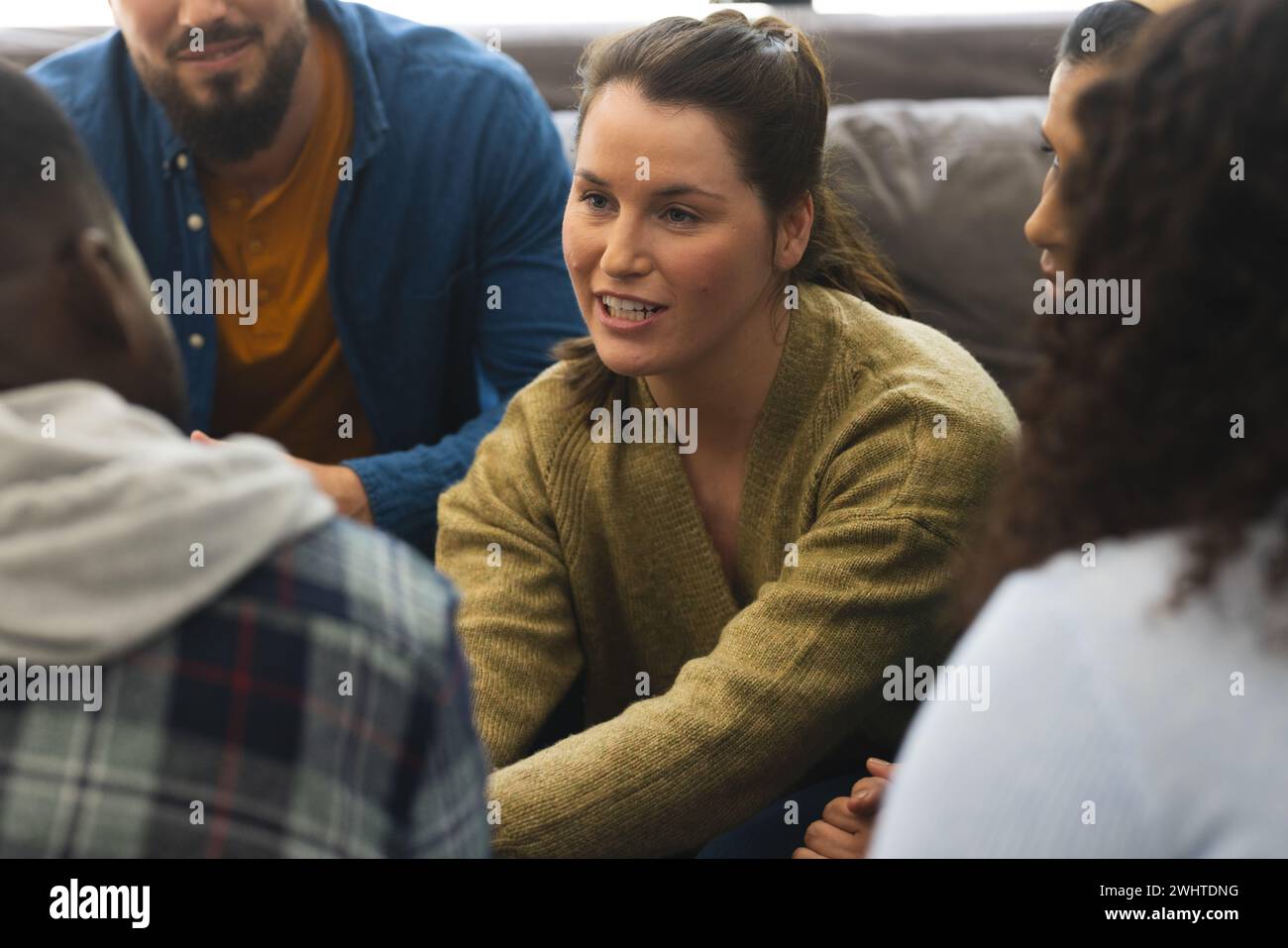 Diverse group of friends talking and supporting each other on therapy ...