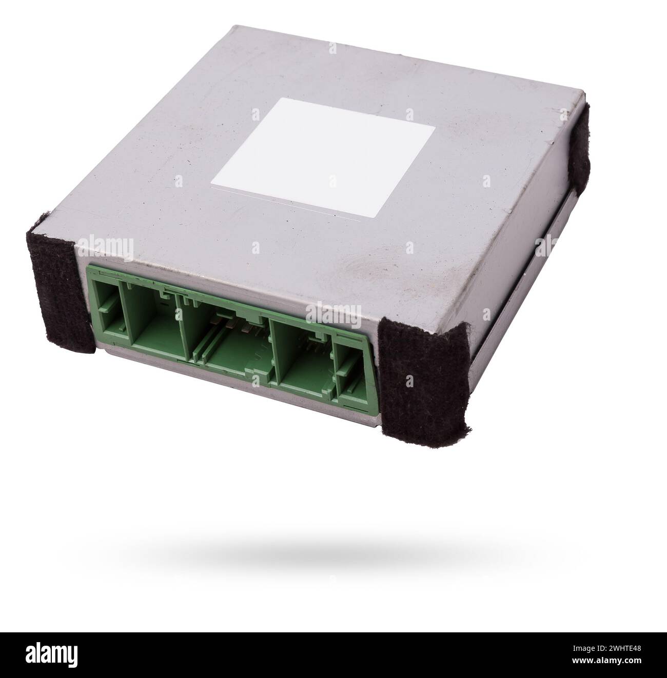 Metallic car engine control unit with plastic elements on a white ...