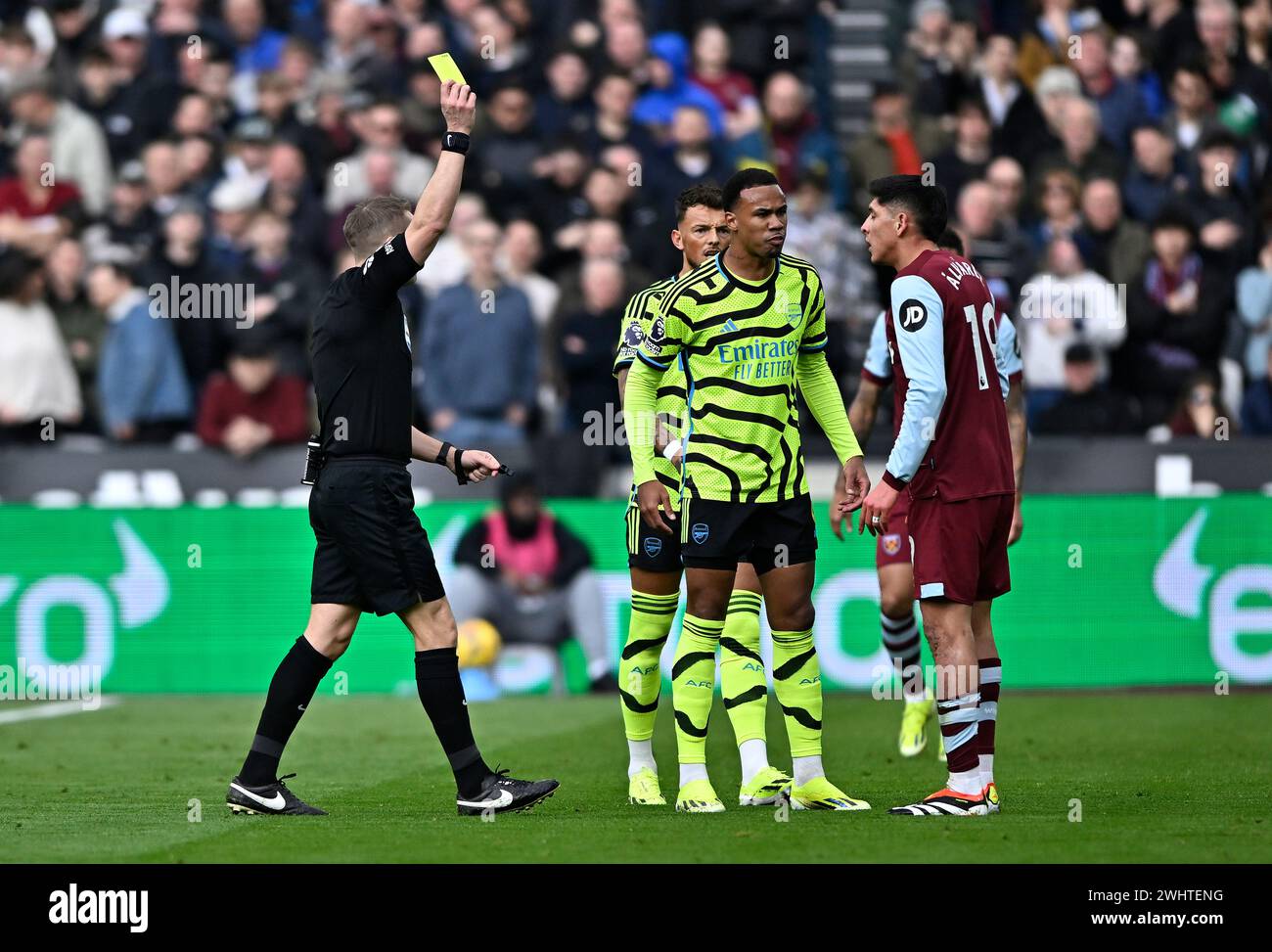 London, UK. 11th Feb, 2024. Craig Pawson (Referee) shows the yellow card to Edson Álvarez (West ...