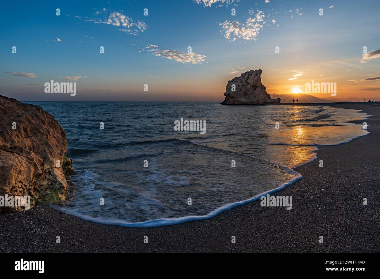 Playa Peñon del Cuervo, beach in the city of Malaga with a rock ...