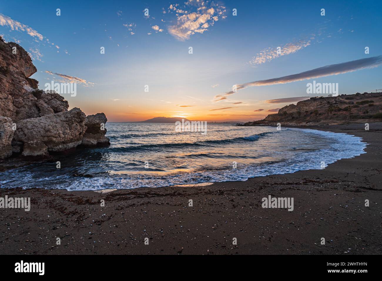 Playa Peñon del Cuervo, beach in the city of Malaga with a rock ...