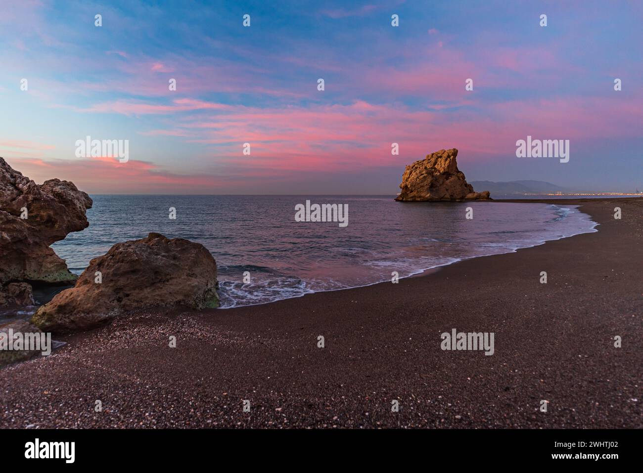 Playa Peñon del Cuervo, beach in the city of Malaga with a rock ...