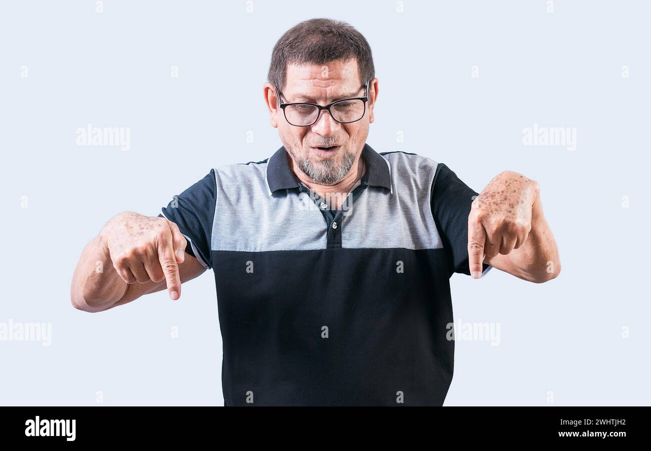 Surprised senior man pointing at a banner down. Senior old man pointing ...