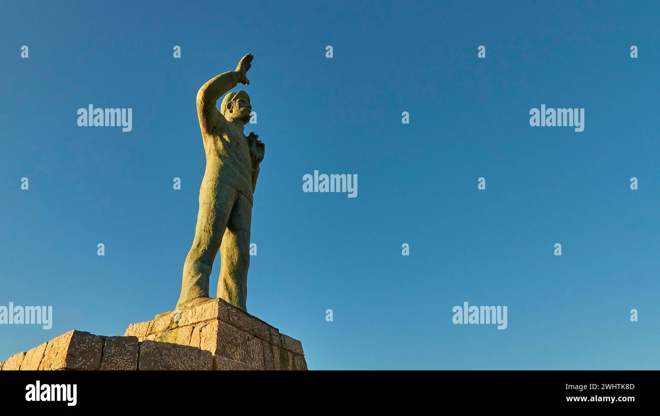 Statue of a man pointing to the sky, standing on a pedestal, bronze ...