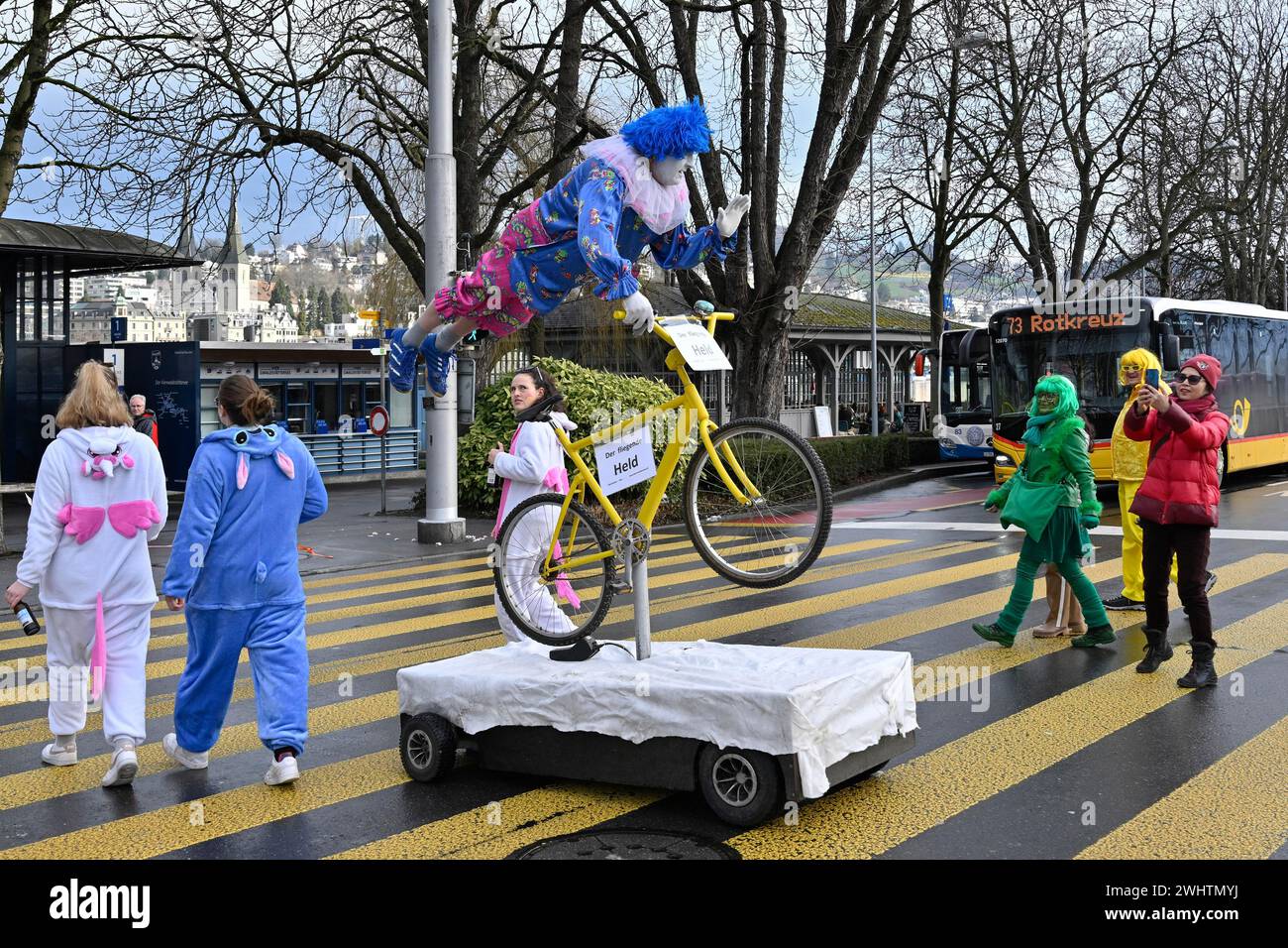 Carnival reveller flying hero on bicycle Stock Photo - Alamy