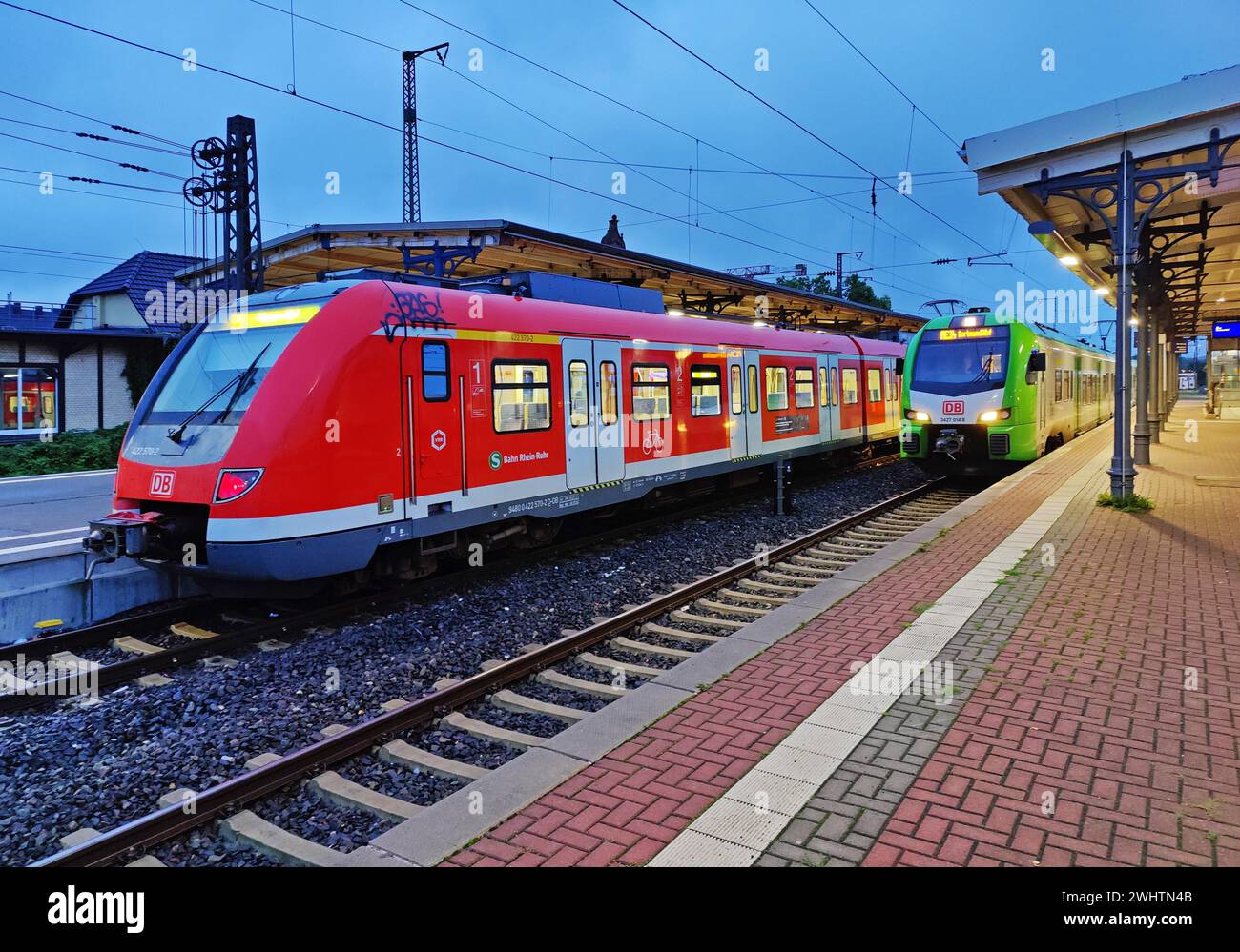 Deserted platform in the early morning with two regional trains, main ...