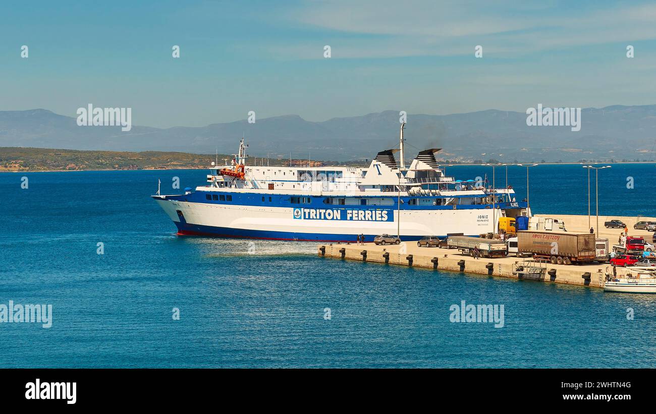 Ferry in the harbour loaded with trucks, surrounded by sea and ...
