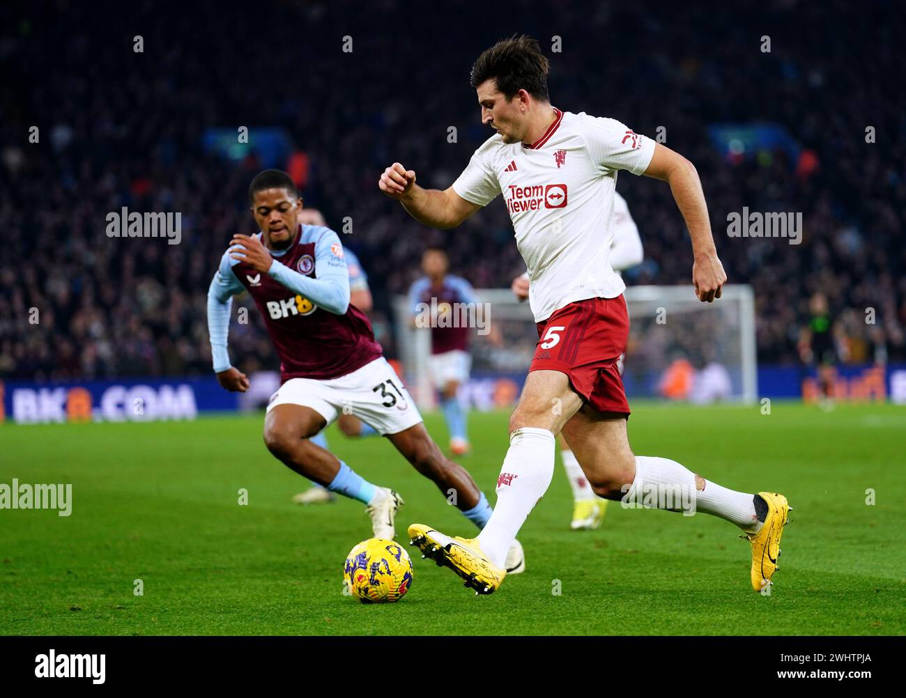 Manchester United's Harry Maguire (right) and Aston Villa's Leon Bailey ...
