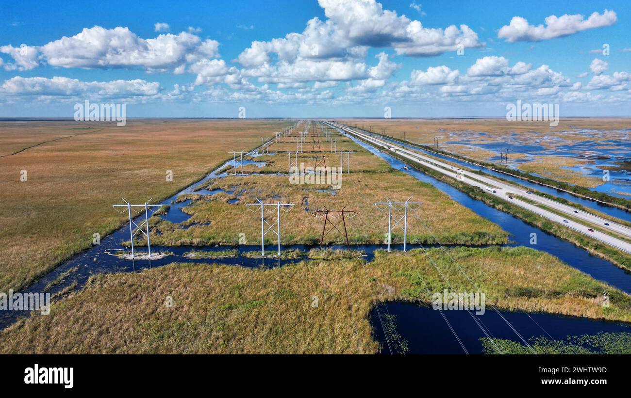 Road with multiple power lines running through it Stock Photo - Alamy