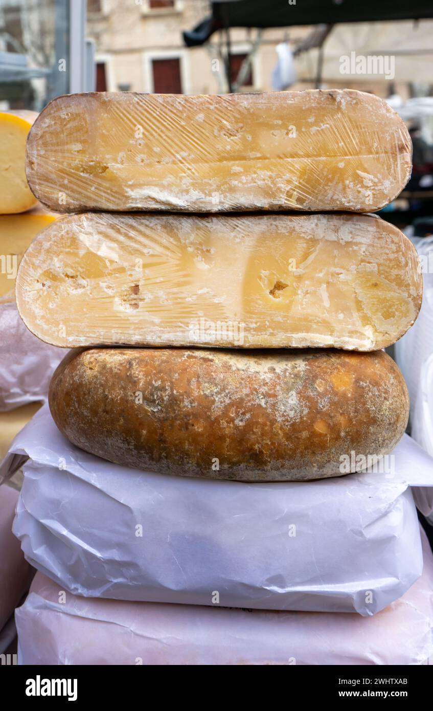 Artisanal Cheese Wheels Stacked at a Rustic Outdoor Market Stock Photo ...