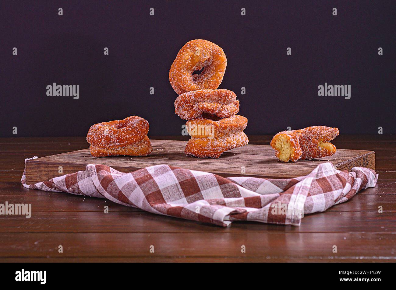 Rustic Bakery Delights: Tower of Donuts on Dark Wood Background Stock ...