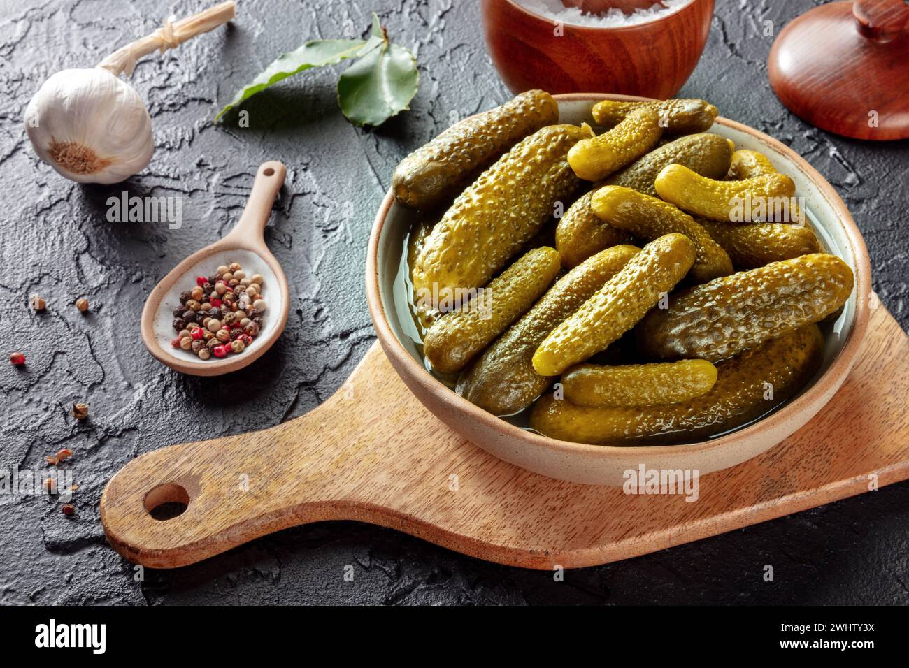 Pickled cucumbers with salt, pepper, garlic, and bay leaf Stock Photo ...