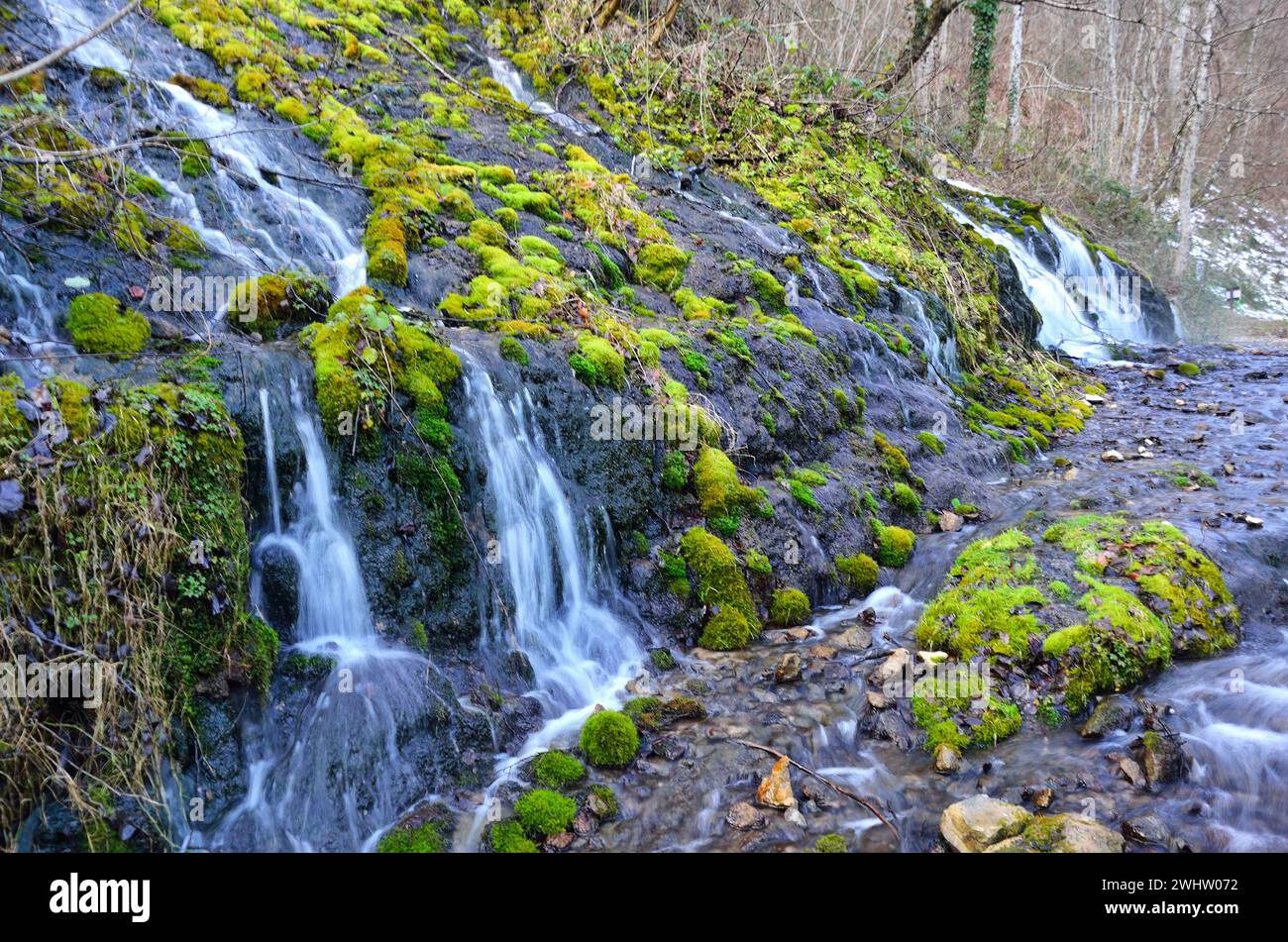 A breathtaking waterfall cascading down a picturesque hillside Stock ...