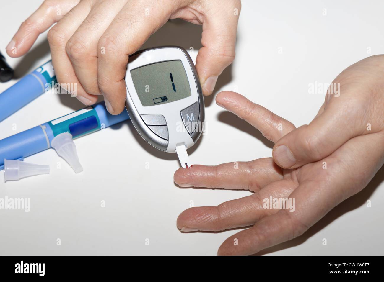 Diabetic man measuring blood sugar level. Blood test for diabetes Stock ...