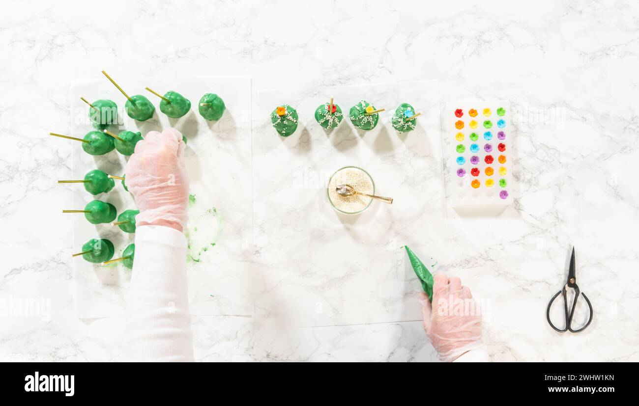 Flat lay. Decorating cactus cake pops with luster dust, sugar glower ...