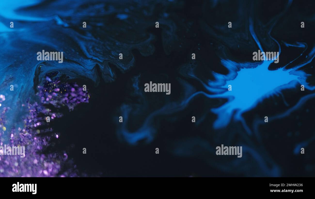 Paint spill ink mix water blue black glitter fluid Stock Photo - Alamy