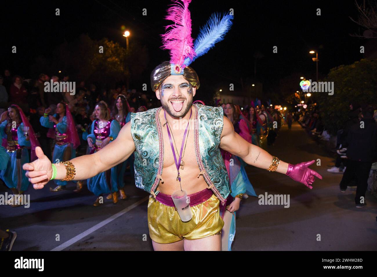 Cunit, Spain. 10th Feb, 2024. A man in costume dances during the 2024 ...