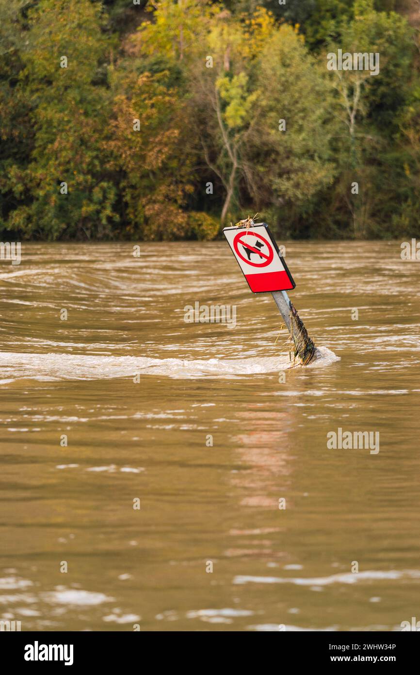 Road sign and sidewalk flooded due to river overflow due to constant ...