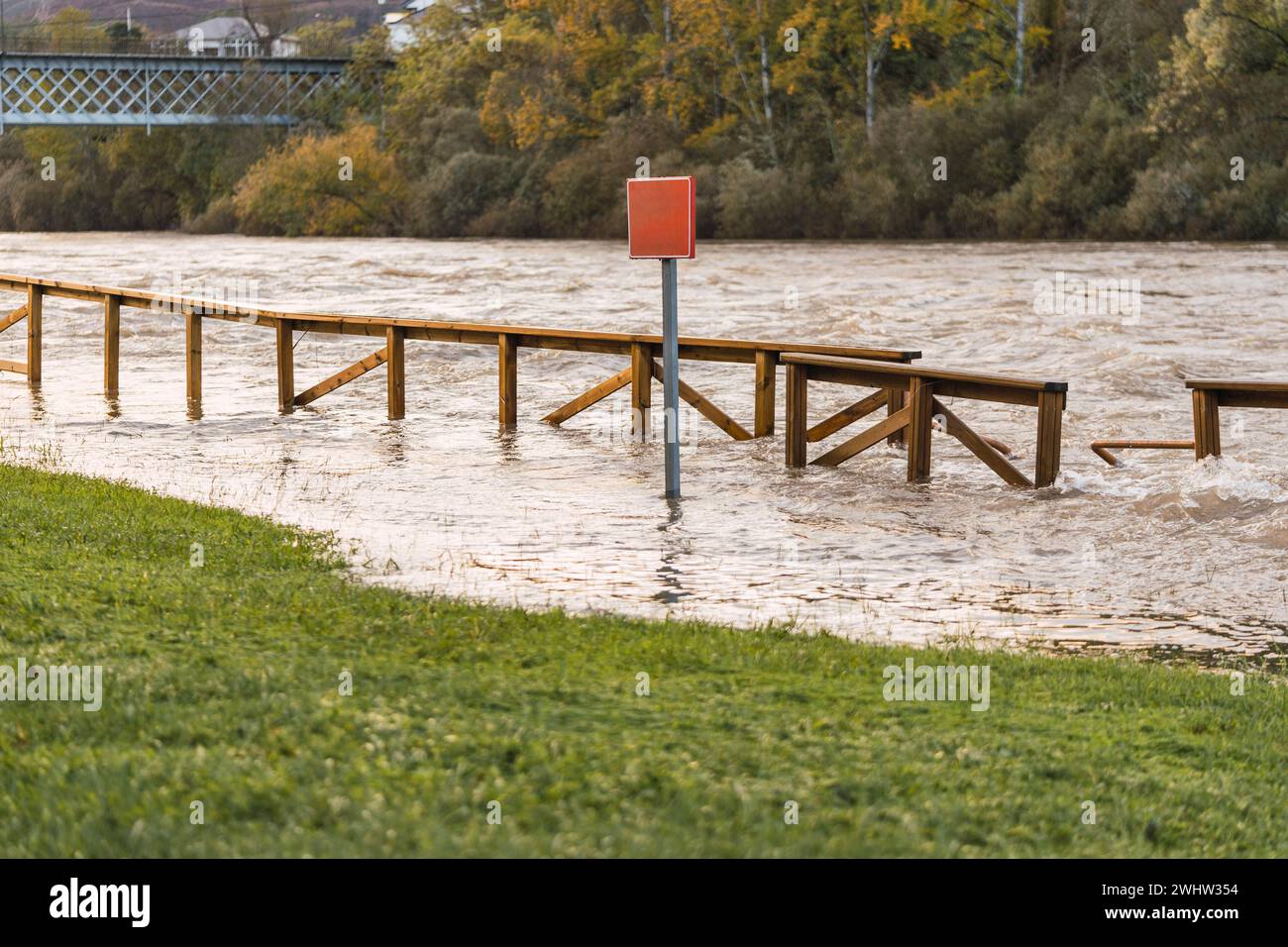 Road sign and sidewalk flooded due to river overflow due to constant ...