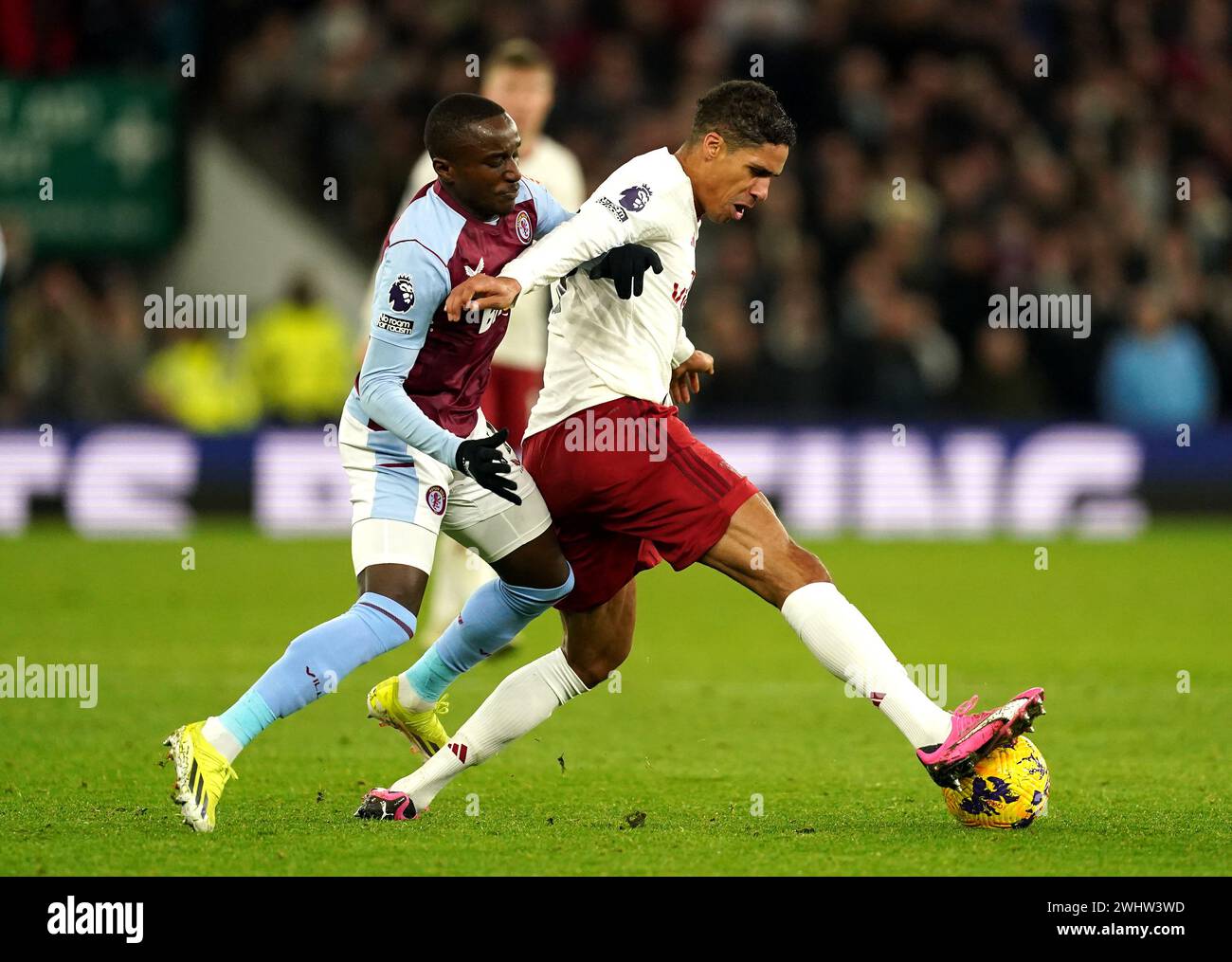 Aston Villa's Moussa Diaby (left) and Manchester United's Raphael ...