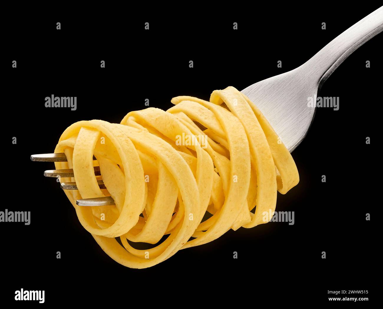 Fork with spaghetti, fettuccine on black background Stock Photo - Alamy