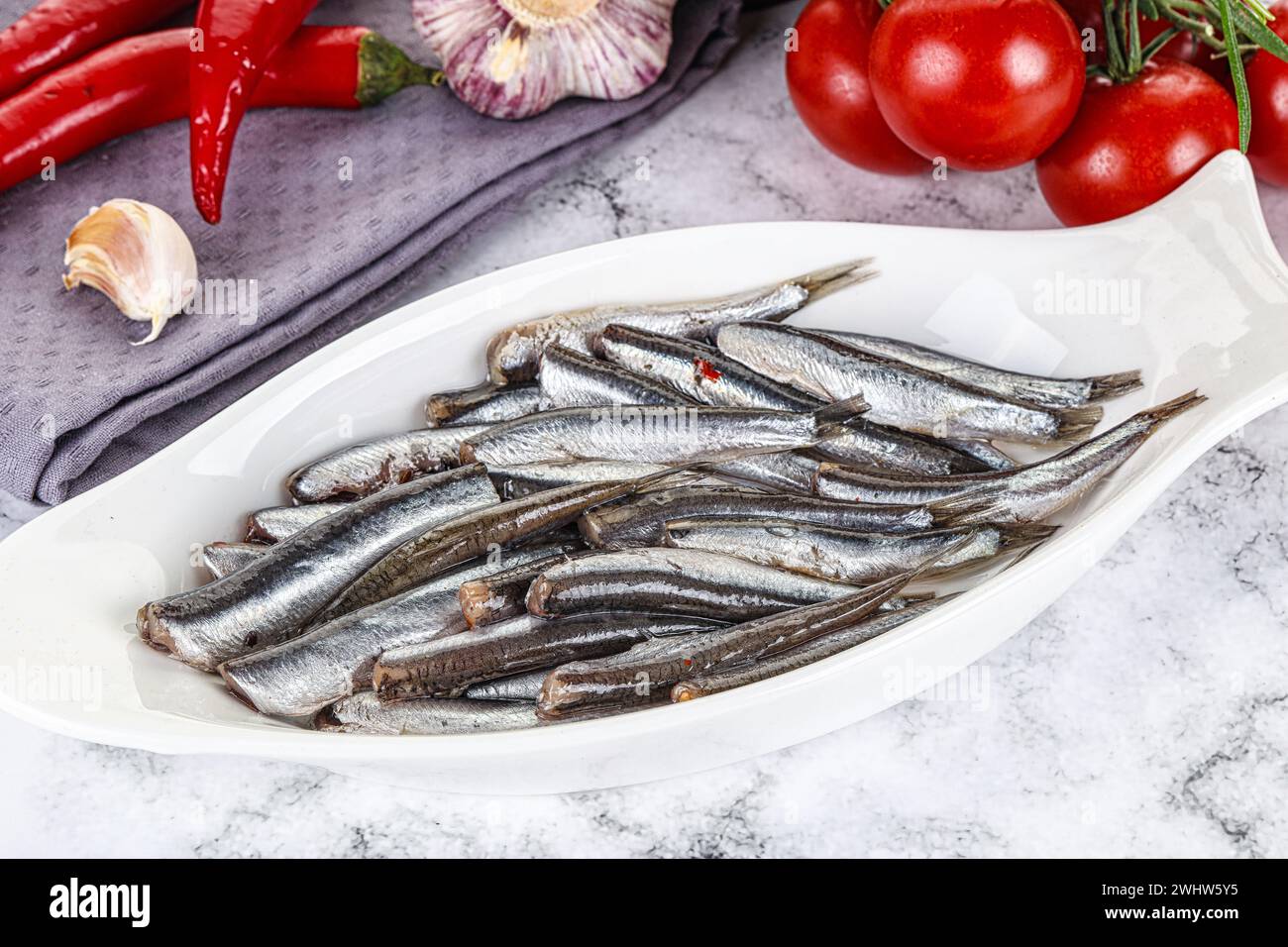 Pickled anchovy fish in the plate Stock Photo - Alamy