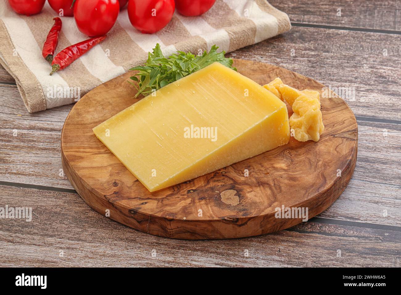 Parmesan hard cheese with small pieces over board Stock Photo - Alamy