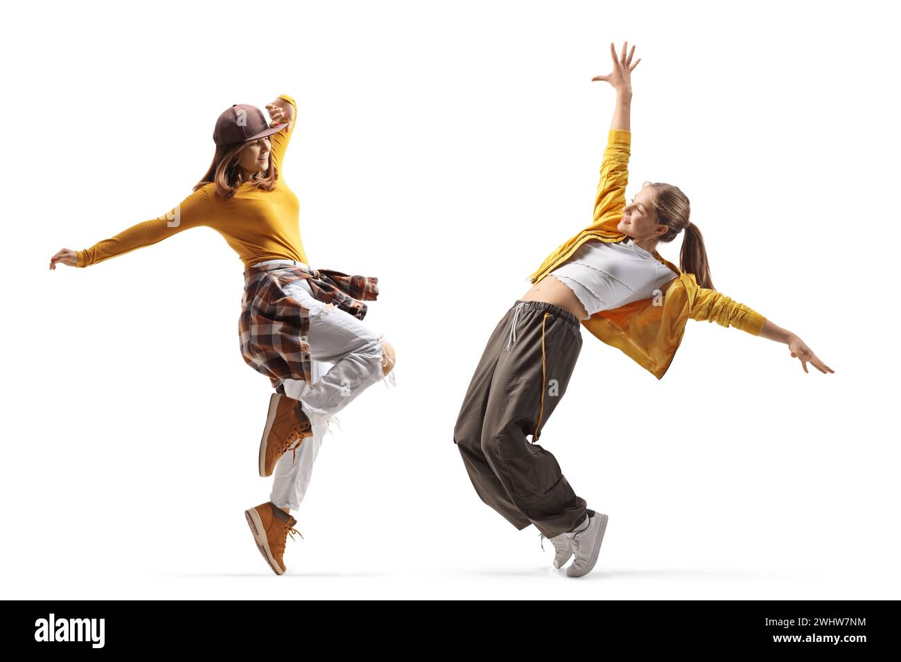 Full length shot of two young women dancing isolated on white ...